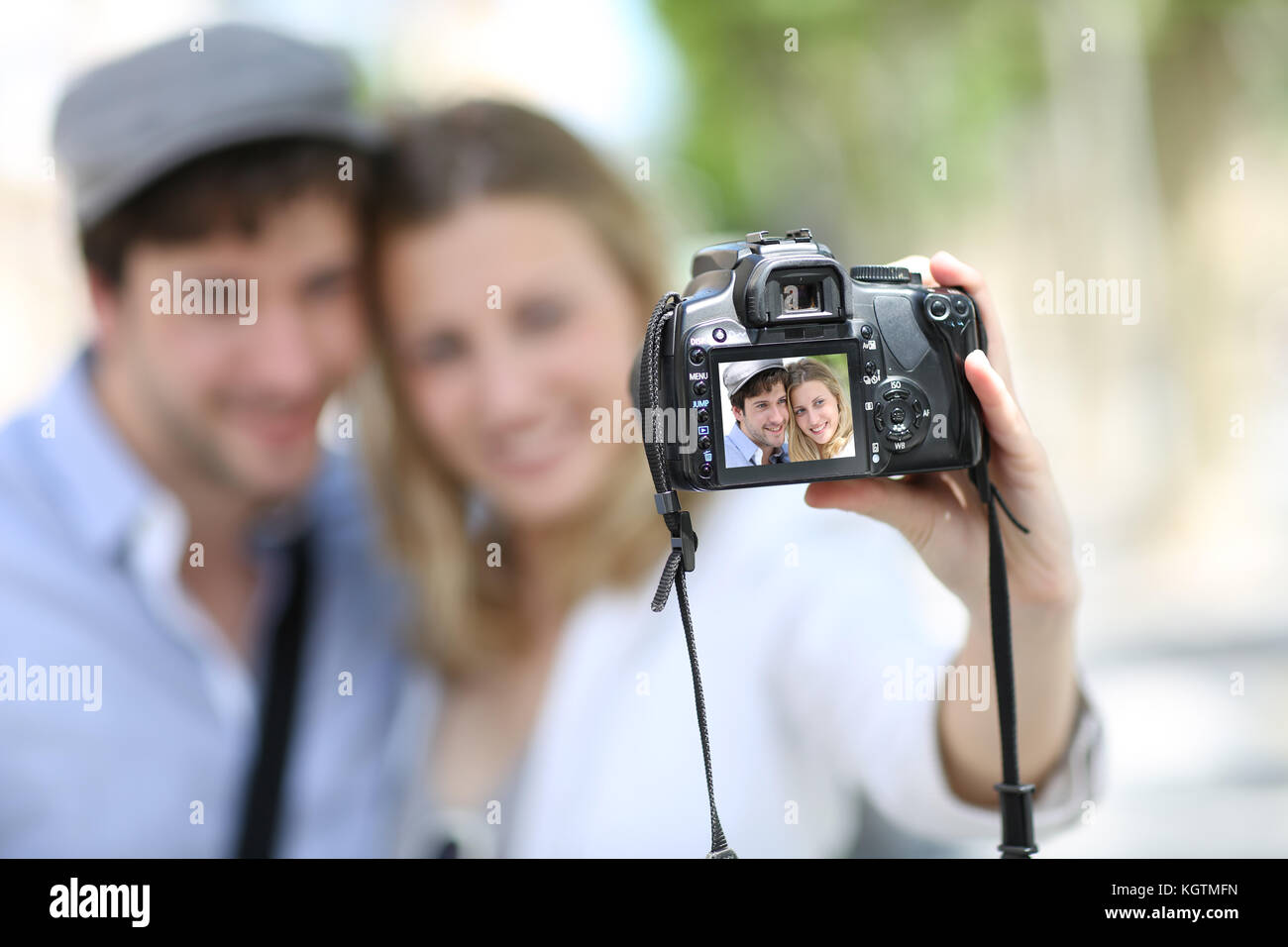 Young couple taking picture of each other Stock Photo - Alamy