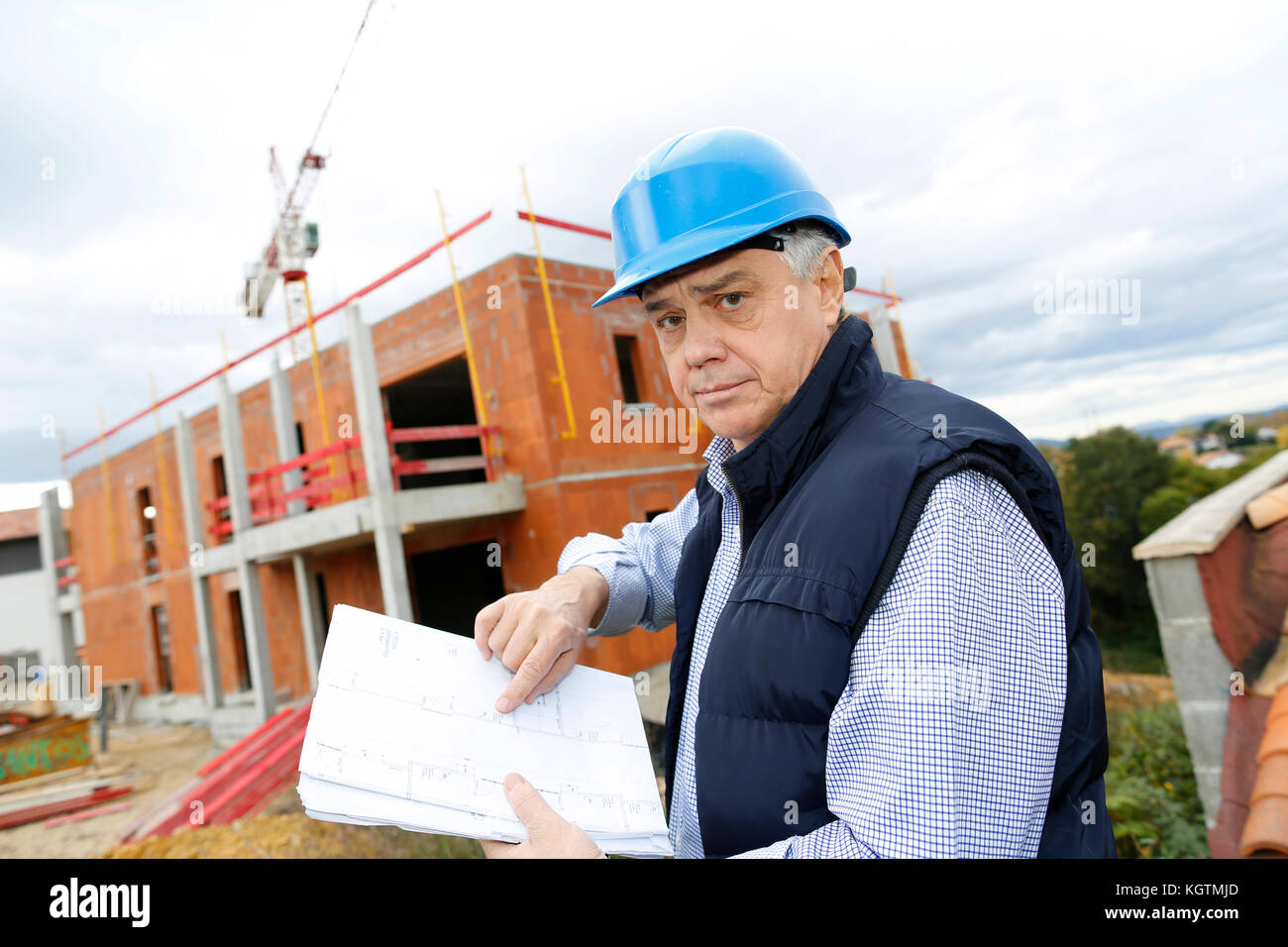 Construction manager checking building project on site Stock Photo - Alamy