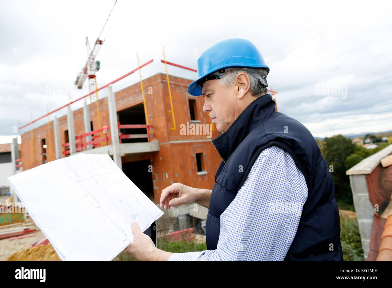 Construction manager checking building project on site Stock Photo - Alamy