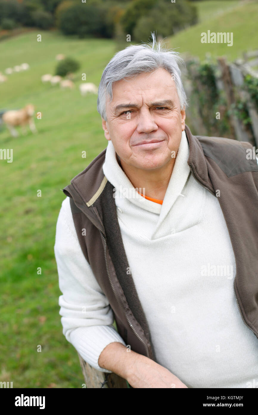 Portrait of senior man standing in field Stock Photo - Alamy
