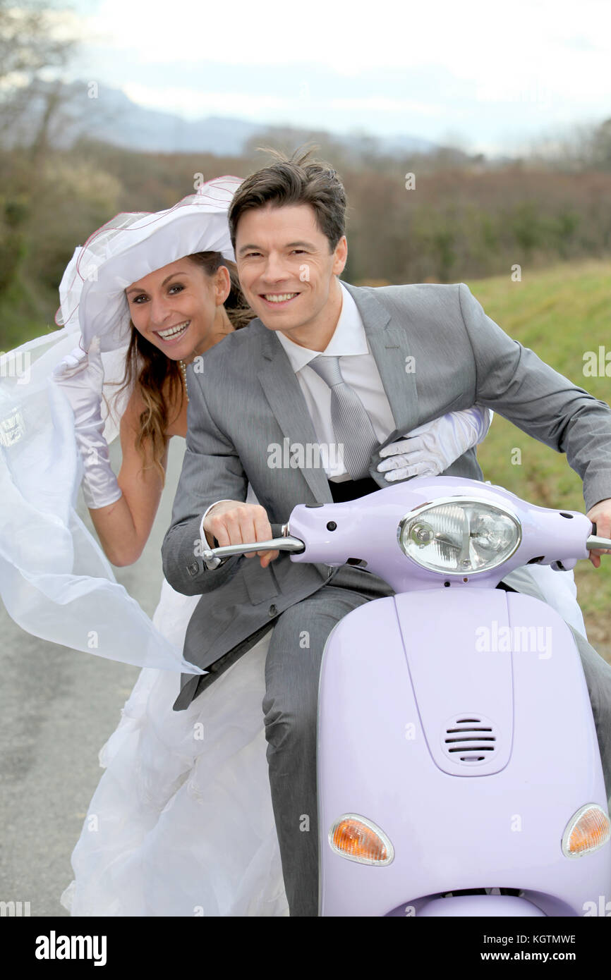 Married couple riding motorcycle on their wedding day Stock Photo - Alamy