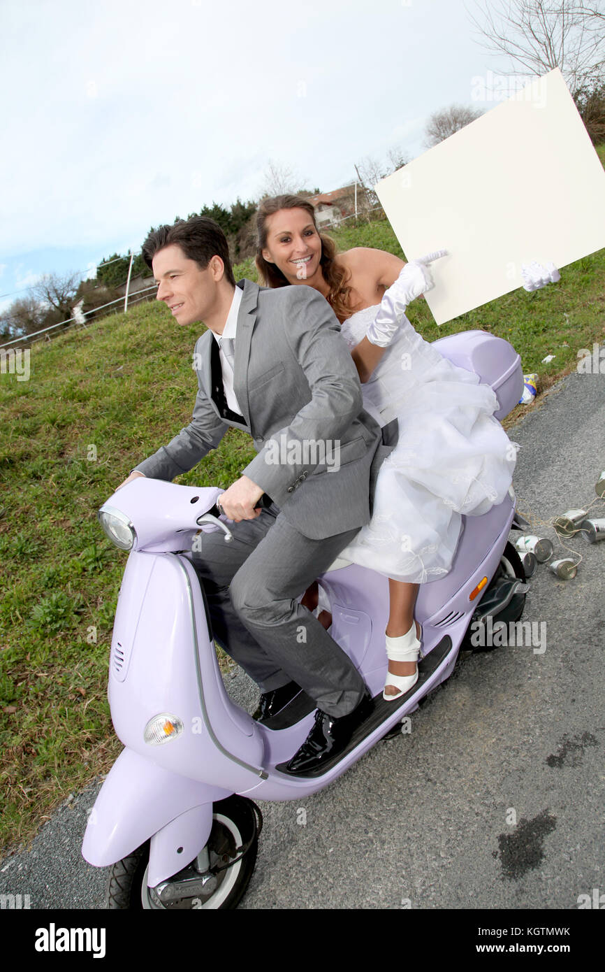 Bride on a motorcycle ride holding whiteboard Stock Photo - Alamy