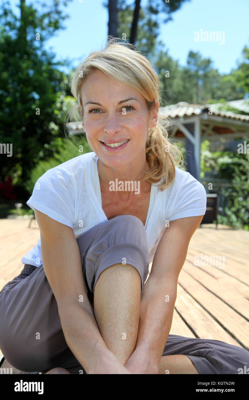 Middle-aged woman doing fitness exercises outside Stock Photo - Alamy