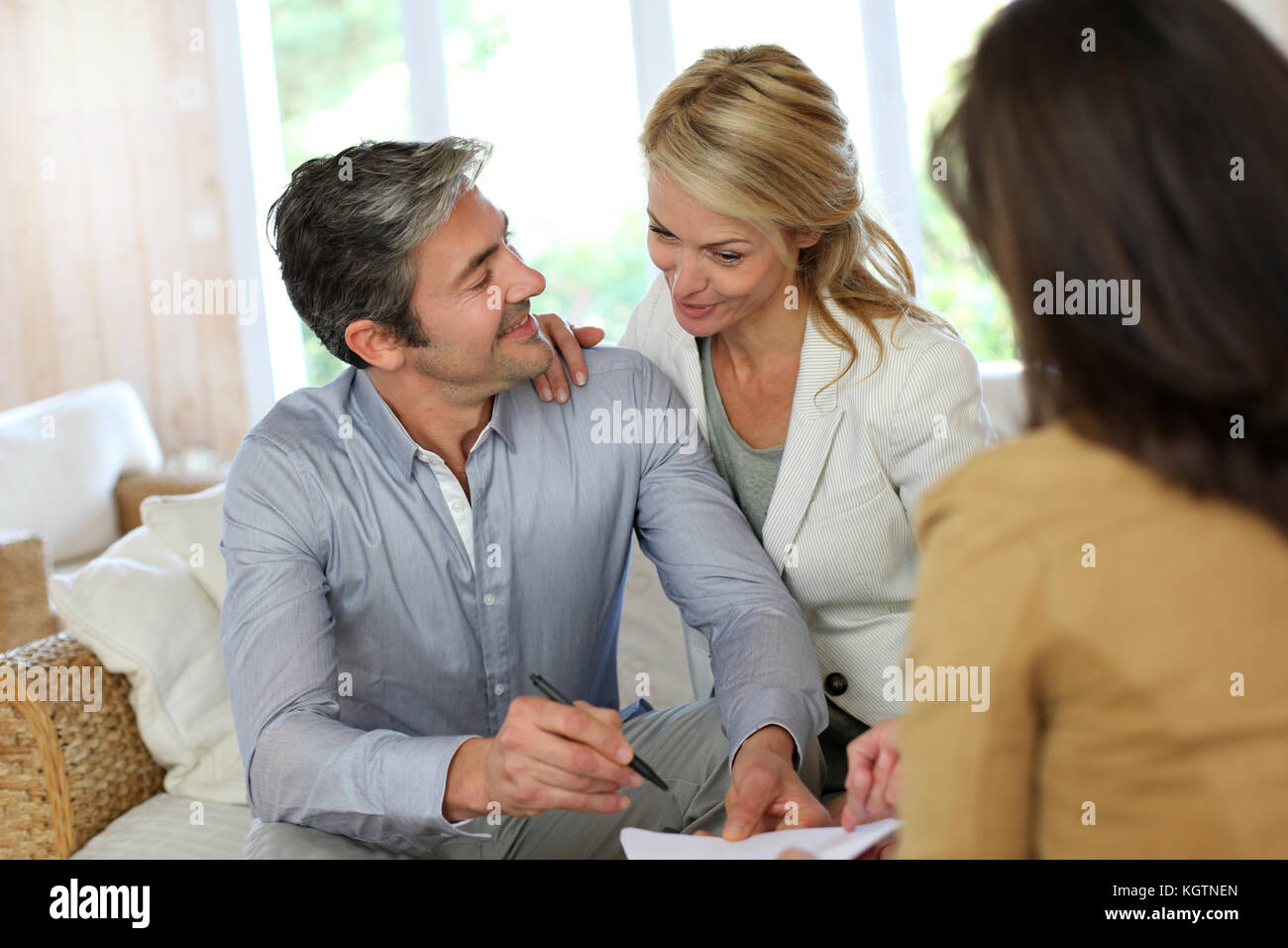 Couple meeting advisor at home Stock Photo - Alamy