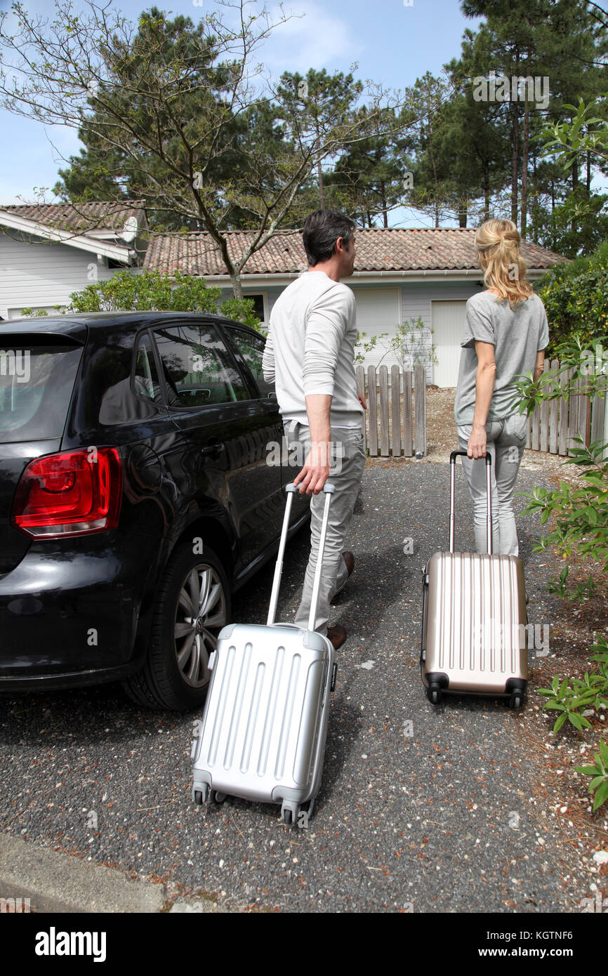 Mature couple coming back home from travel Stock Photo - Alamy