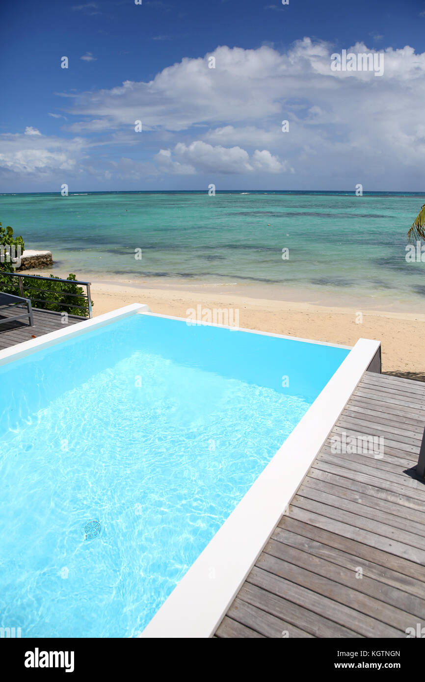 Beautiful view of infinity pool with wooden deck Stock Photo - Alamy