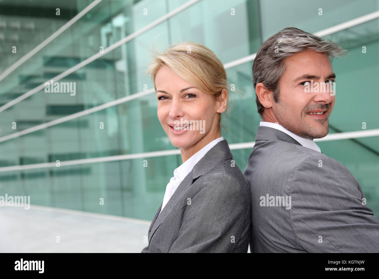 Business people standing back to back Stock Photo - Alamy