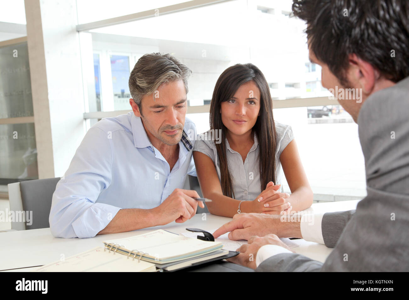 Father and girl signing loan contract Stock Photo - Alamy