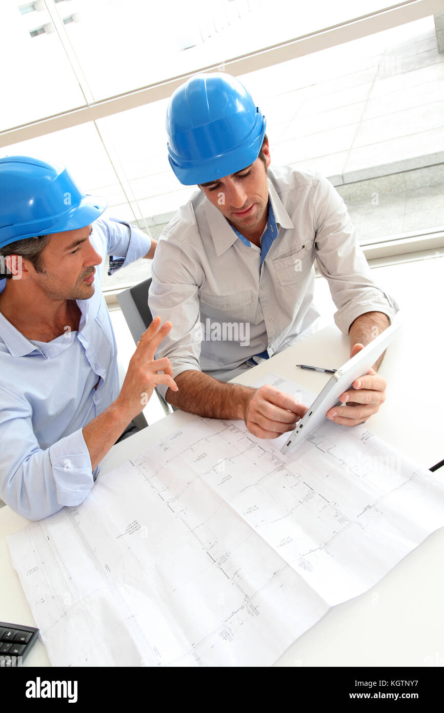 Architects working on construction plan Stock Photo - Alamy