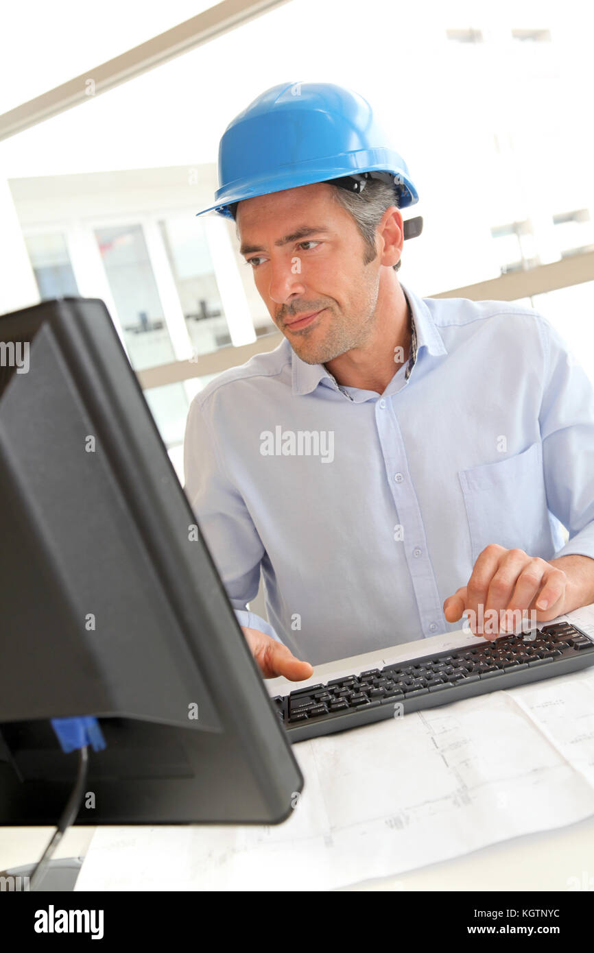 Engineer in office working on construction plan Stock Photo - Alamy