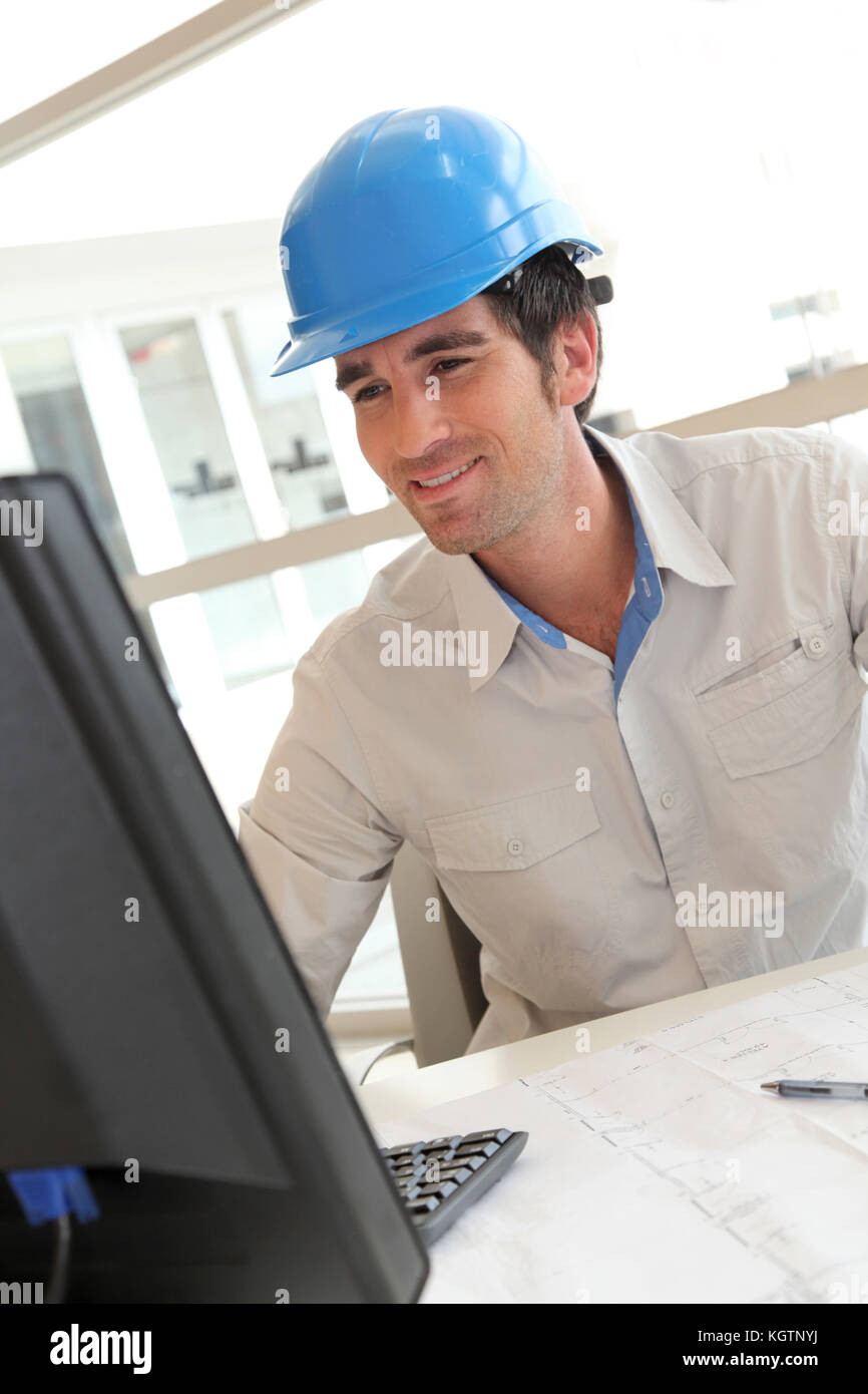 Smiling architect in office working on desktop computer Stock Photo - Alamy