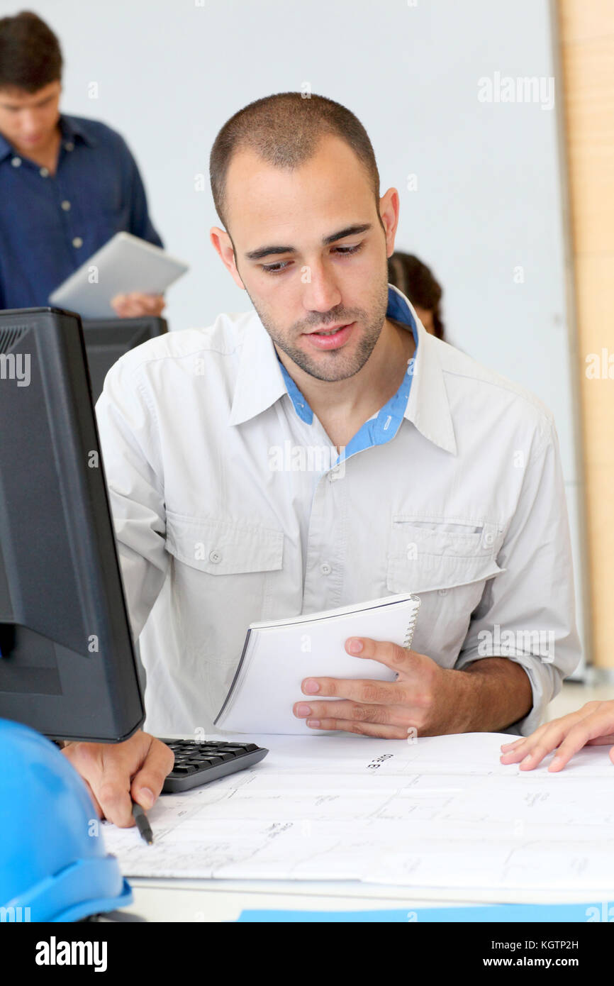 Student writing on notebook Stock Photo - Alamy