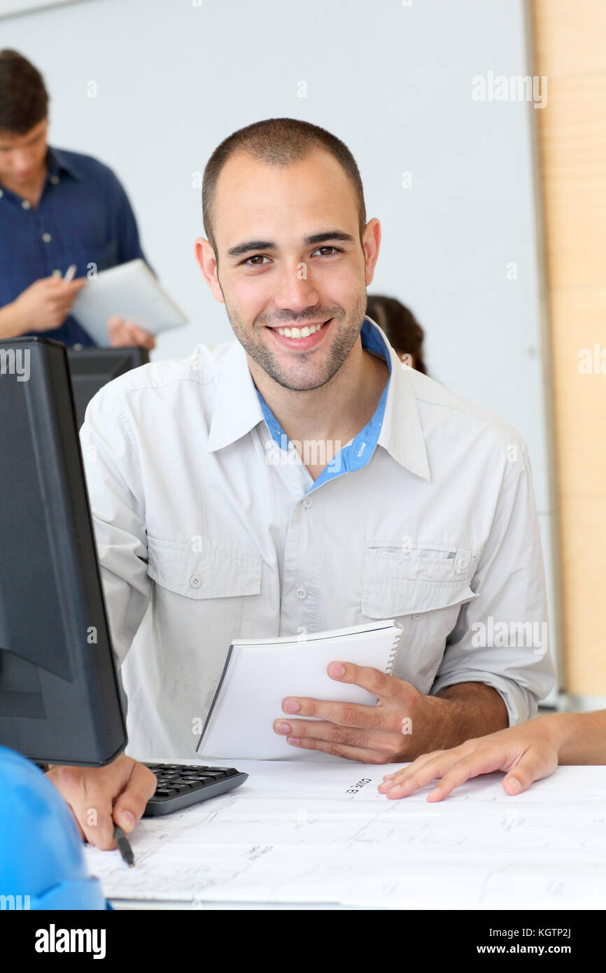 Student writing on notebook Stock Photo - Alamy