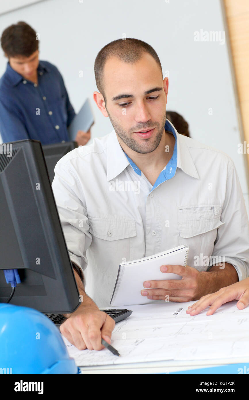 Student writing on notebook Stock Photo - Alamy