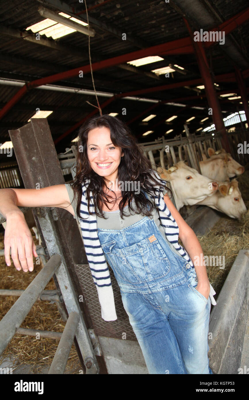 Smiling woman farmer standing in barn Stock Photo - Alamy