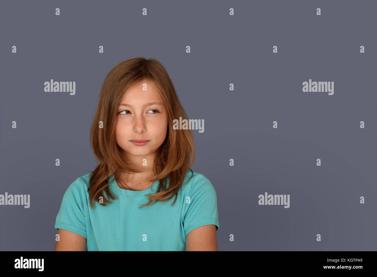 Portrait of young girl with doubtful look Stock Photo - Alamy