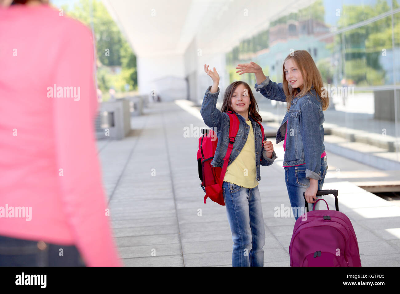 School girls waving goodbye at their mother Stock Photo - Alamy