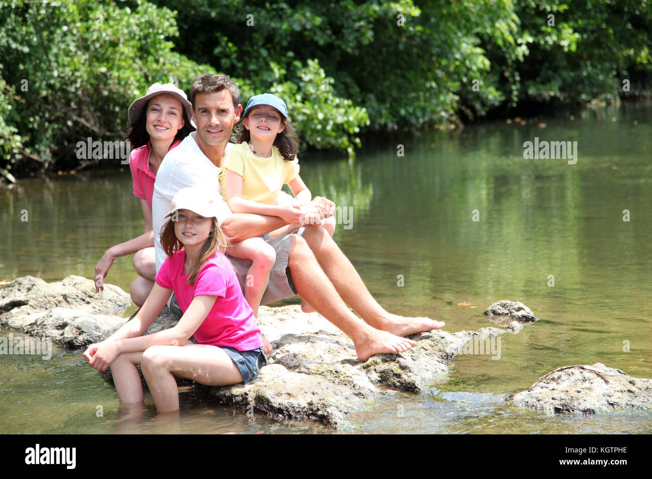 Portrait of family sitting in river in summer Stock Photo - Alamy