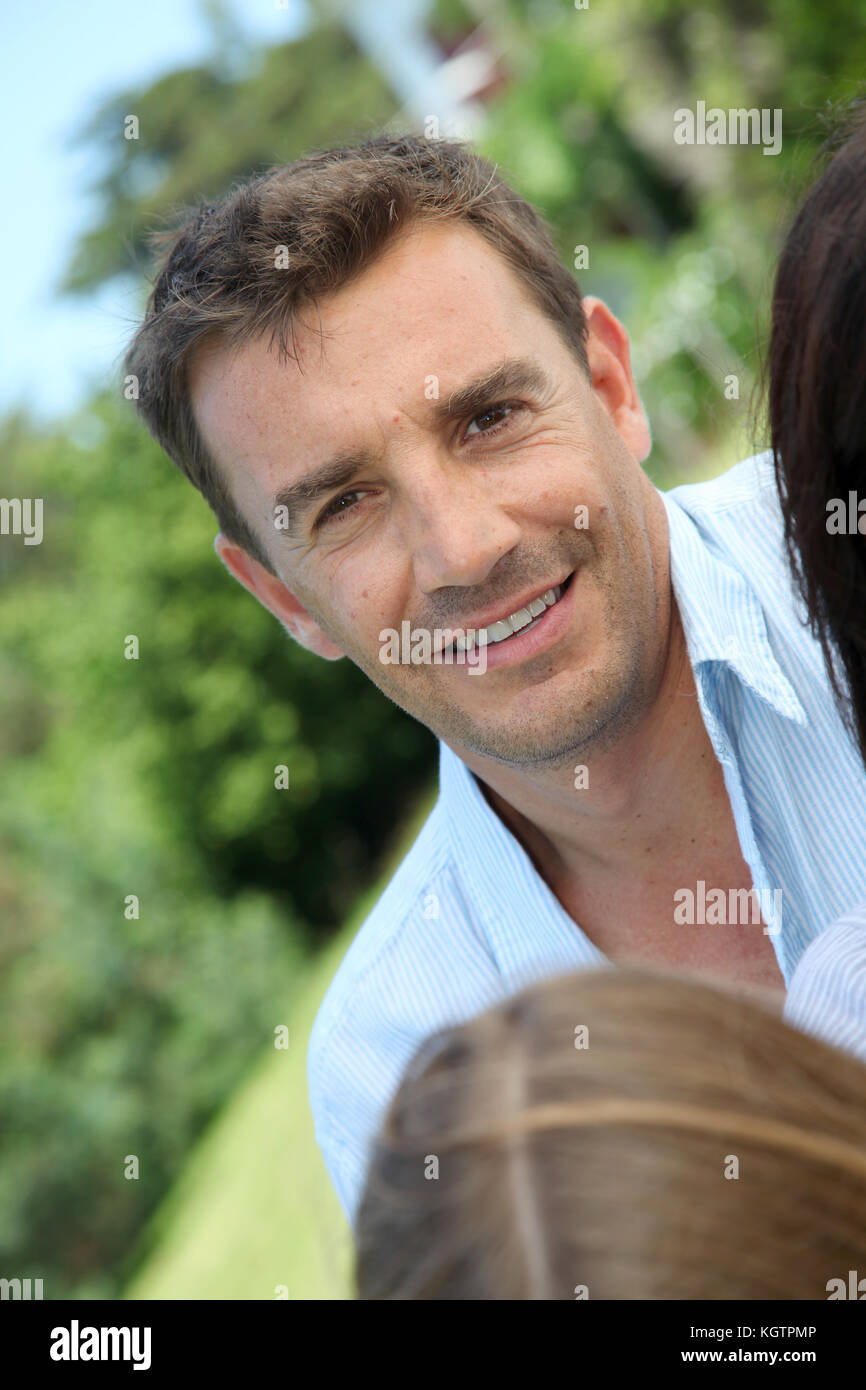 Portrait of man sitting outside in park Stock Photo - Alamy