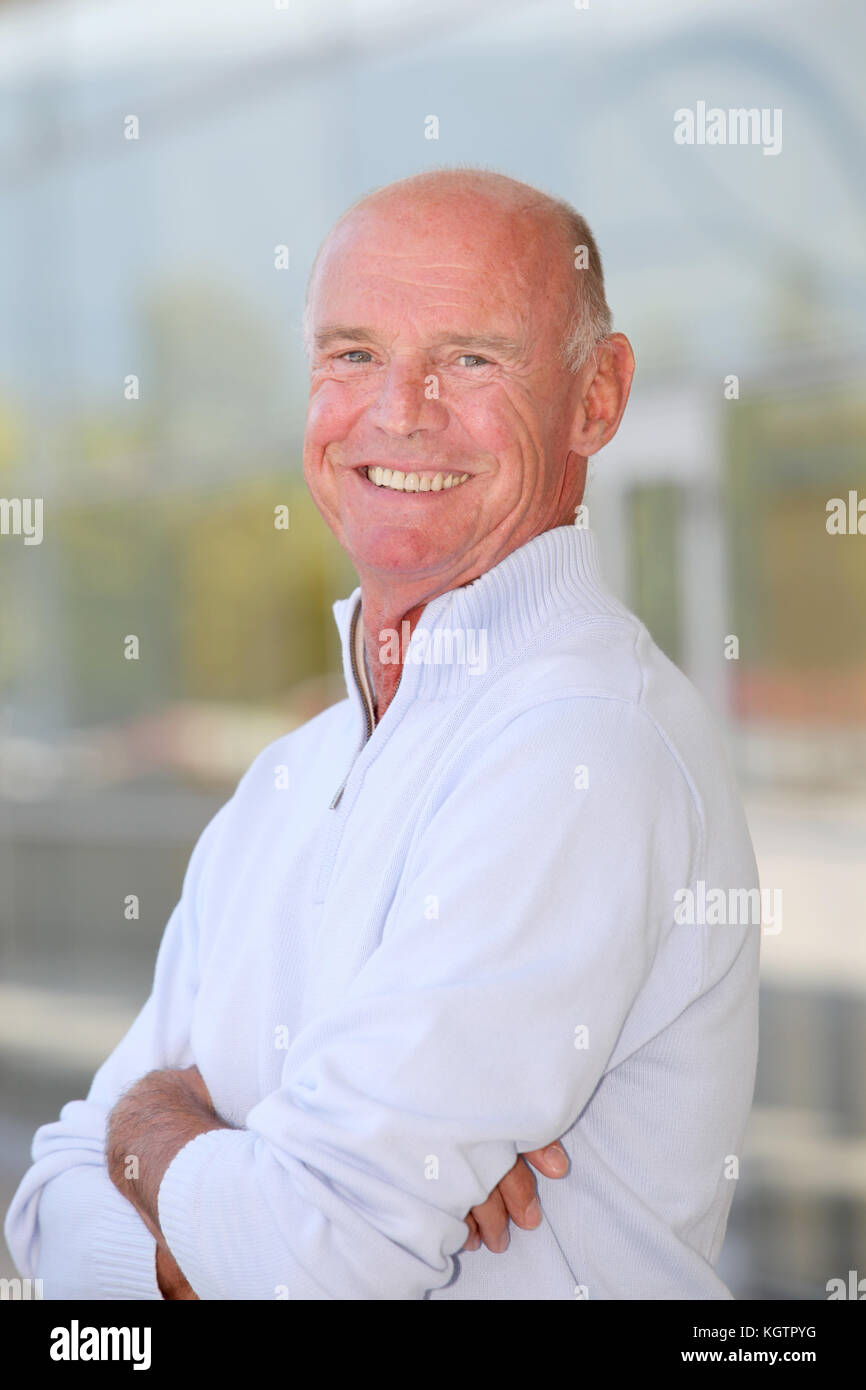 Portrait of handsome senior man with blue sweater Stock Photo - Alamy