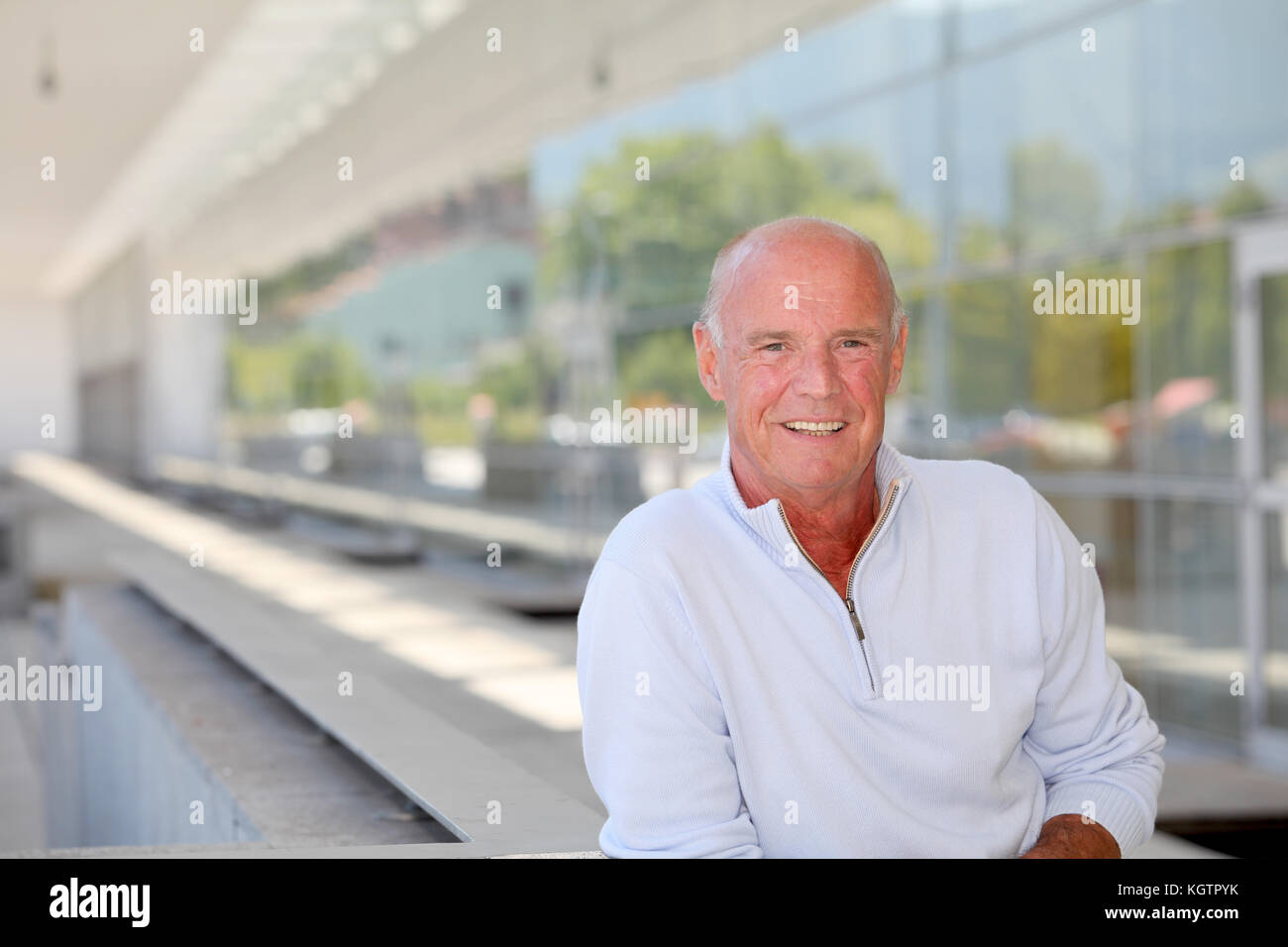 Portrait of handsome senior man with blue sweater Stock Photo - Alamy