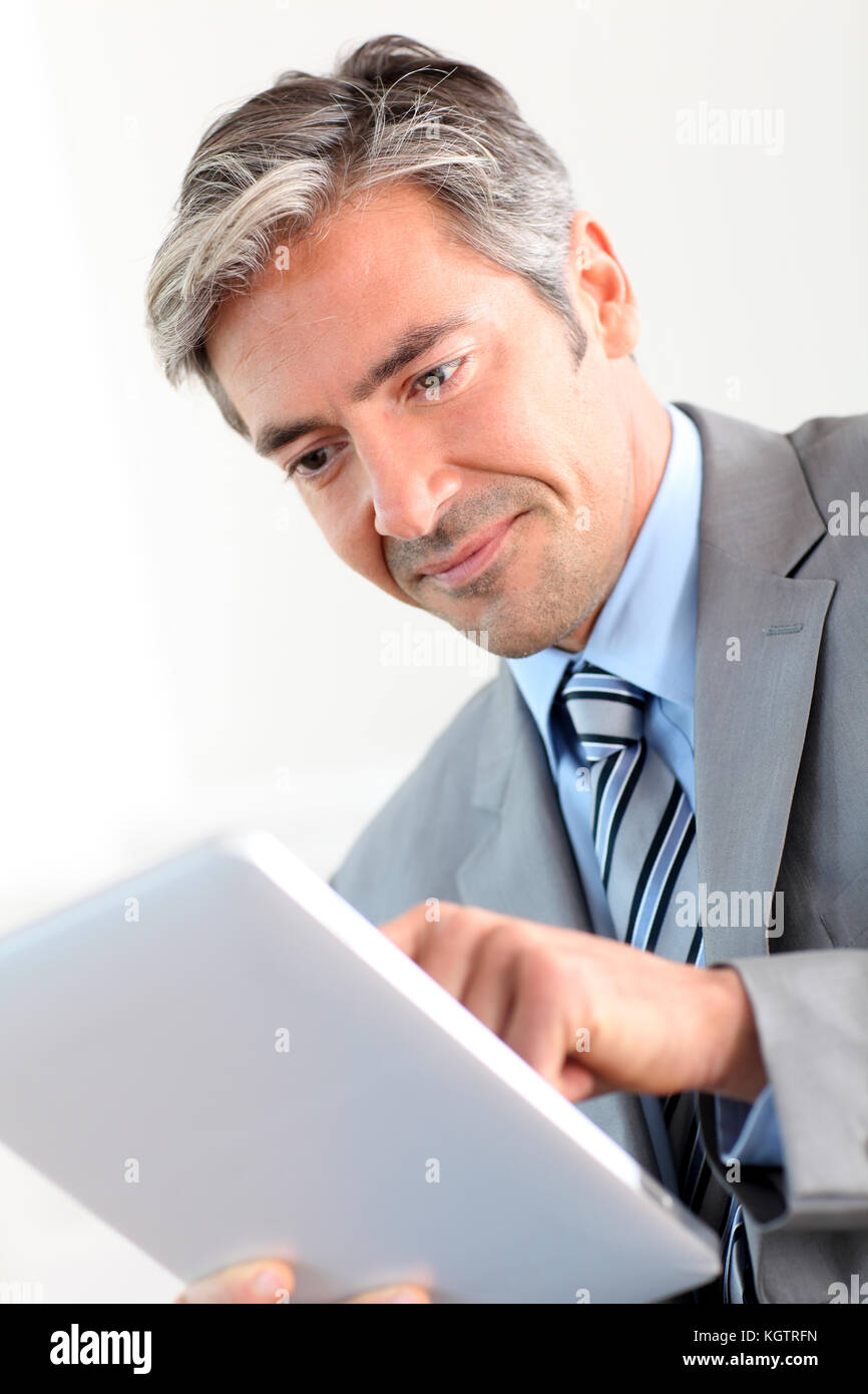 Portrait of businessman using electronic tablet Stock Photo - Alamy