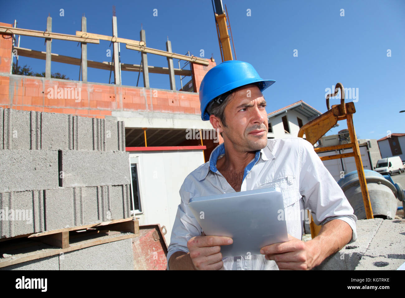 Construction manager using electronic tablet on building site Stock ...