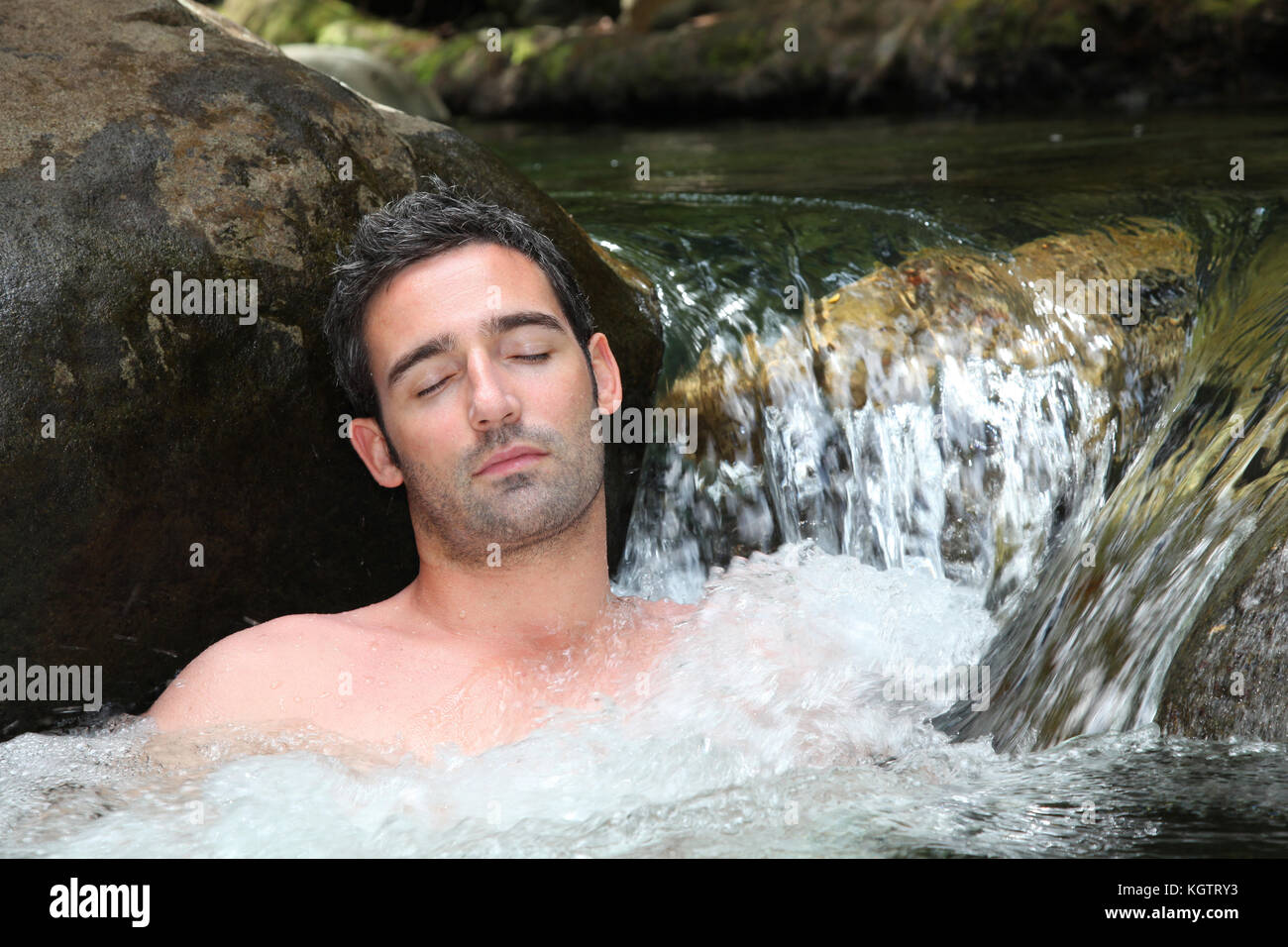 Closeup of man relaxing in natural river spa Stock Photo - Alamy