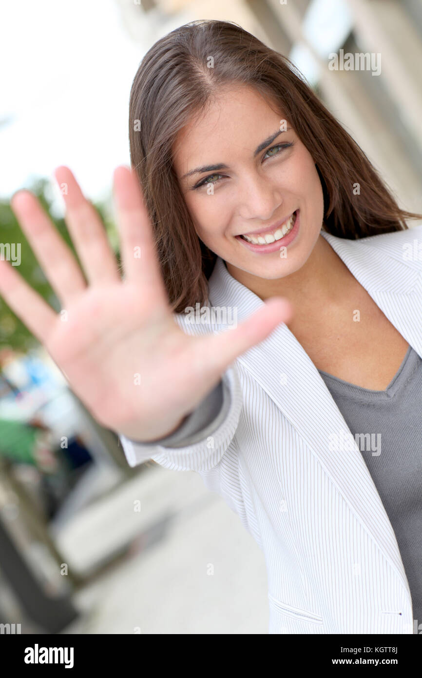 Cheerful woman showing hand to camera Stock Photo - Alamy