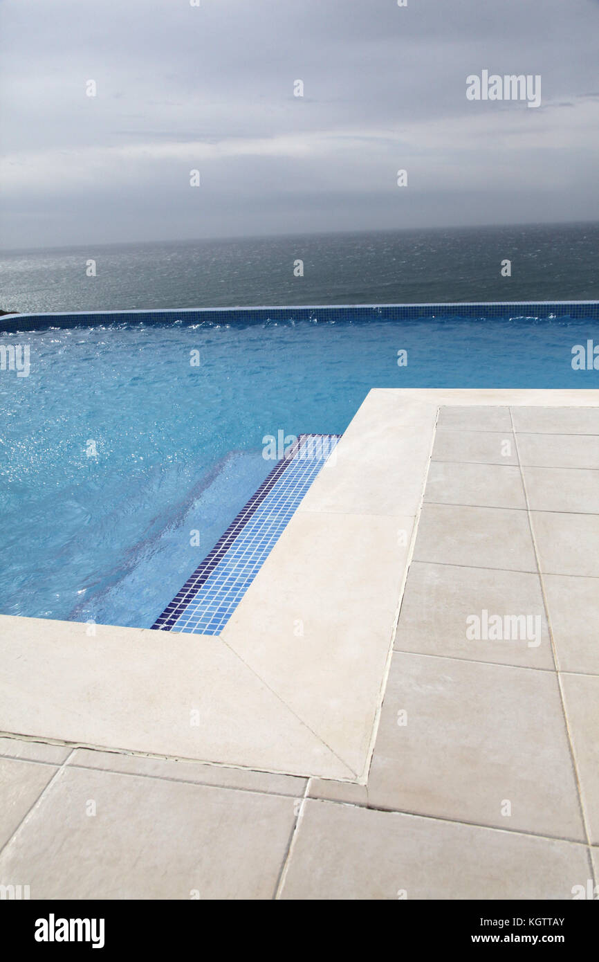 Modern swimming-pool with view towards the ocean Stock Photo - Alamy