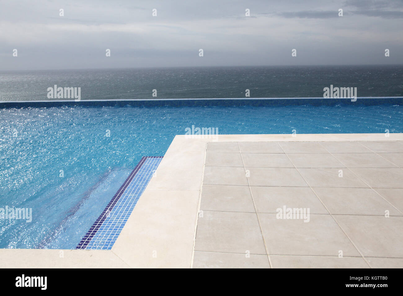 Modern swimming-pool with view towards the ocean Stock Photo - Alamy