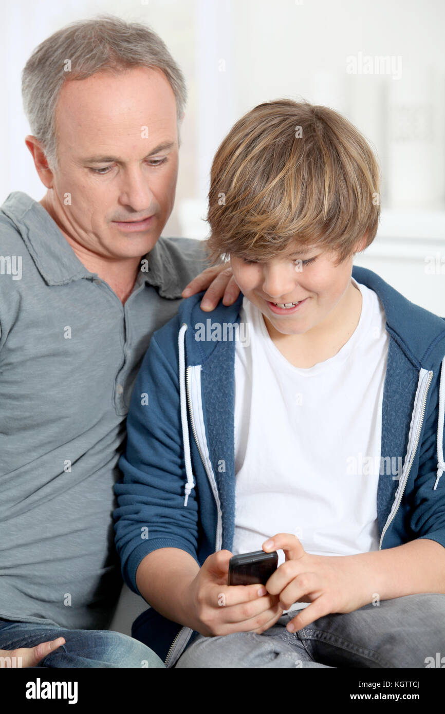 Father and son playing with mobile phone Stock Photo - Alamy