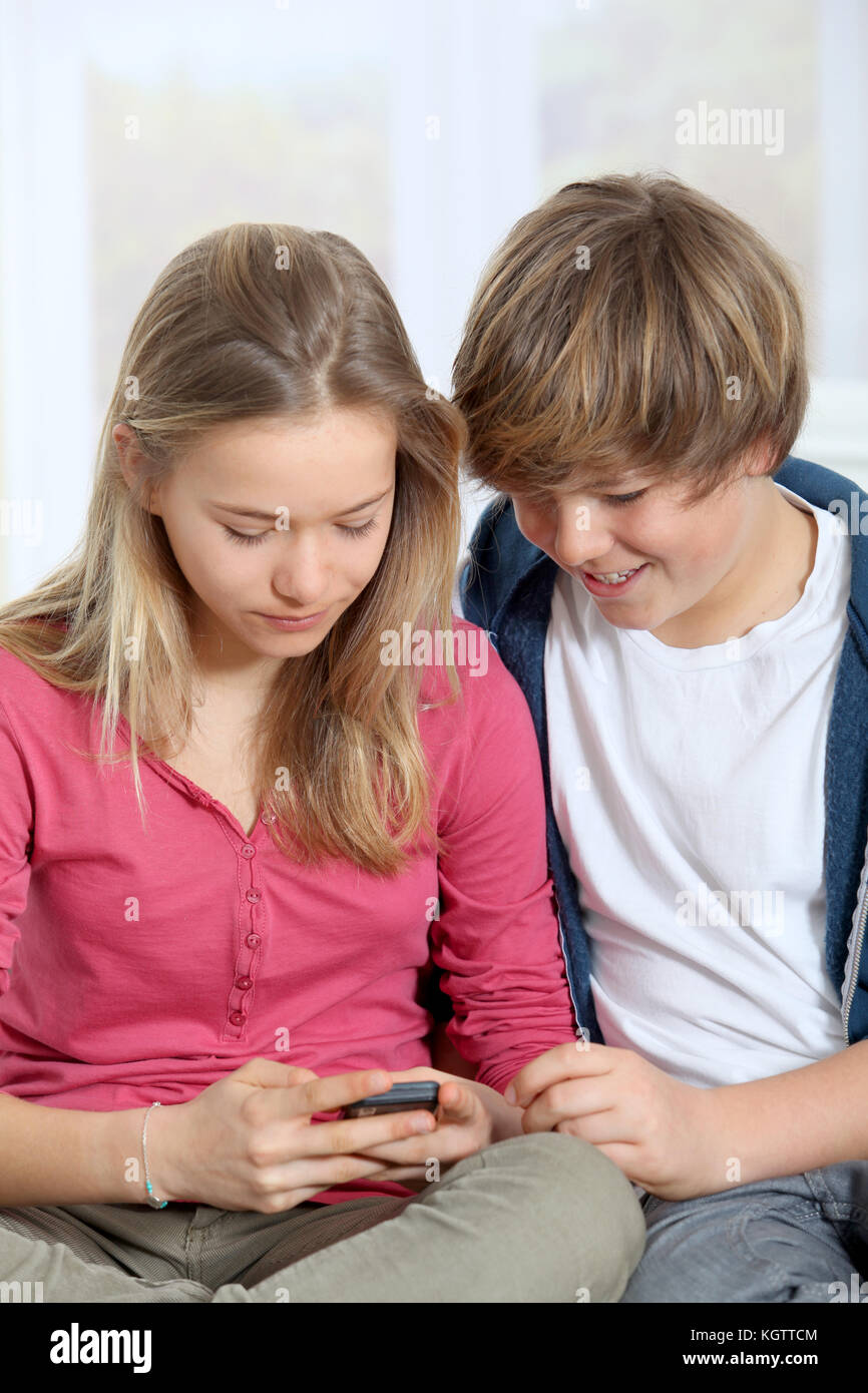 Young teenagers using mobile phone Stock Photo - Alamy
