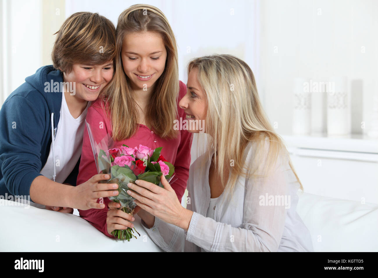 Children offering bunch of flowers on mother's day Stock Photo - Alamy