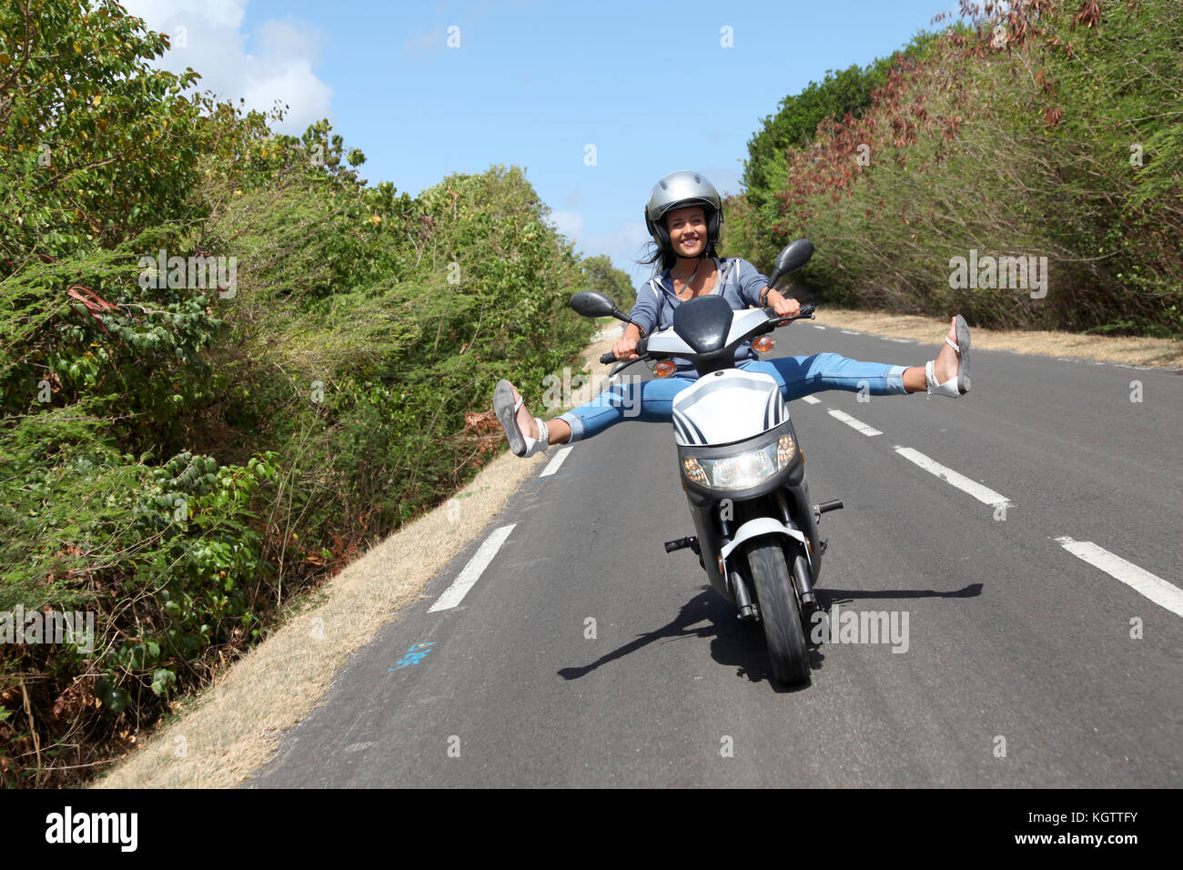 Young woman riding motorbike Stock Photo - Alamy