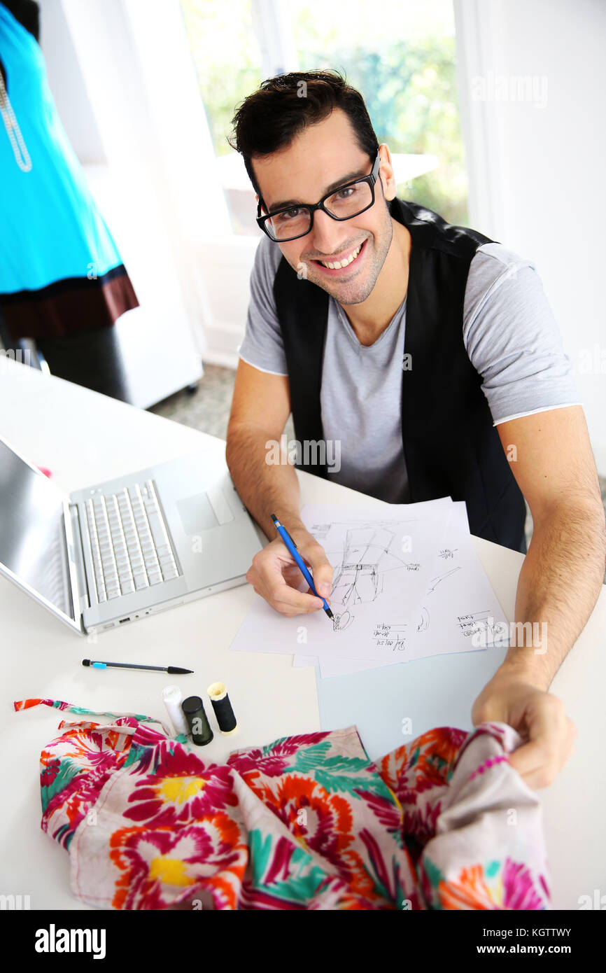 Smiling fashion designer in workshop Stock Photo - Alamy