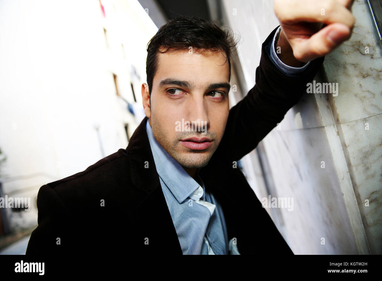 Man with sad look handing out in the street Stock Photo - Alamy