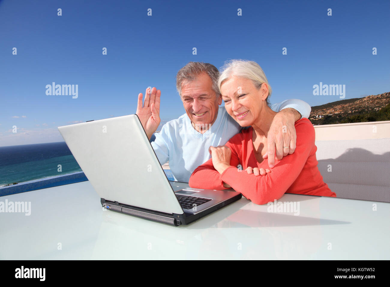 Senior couple waving at webcamera on laptop computer Stock Photo - Alamy
