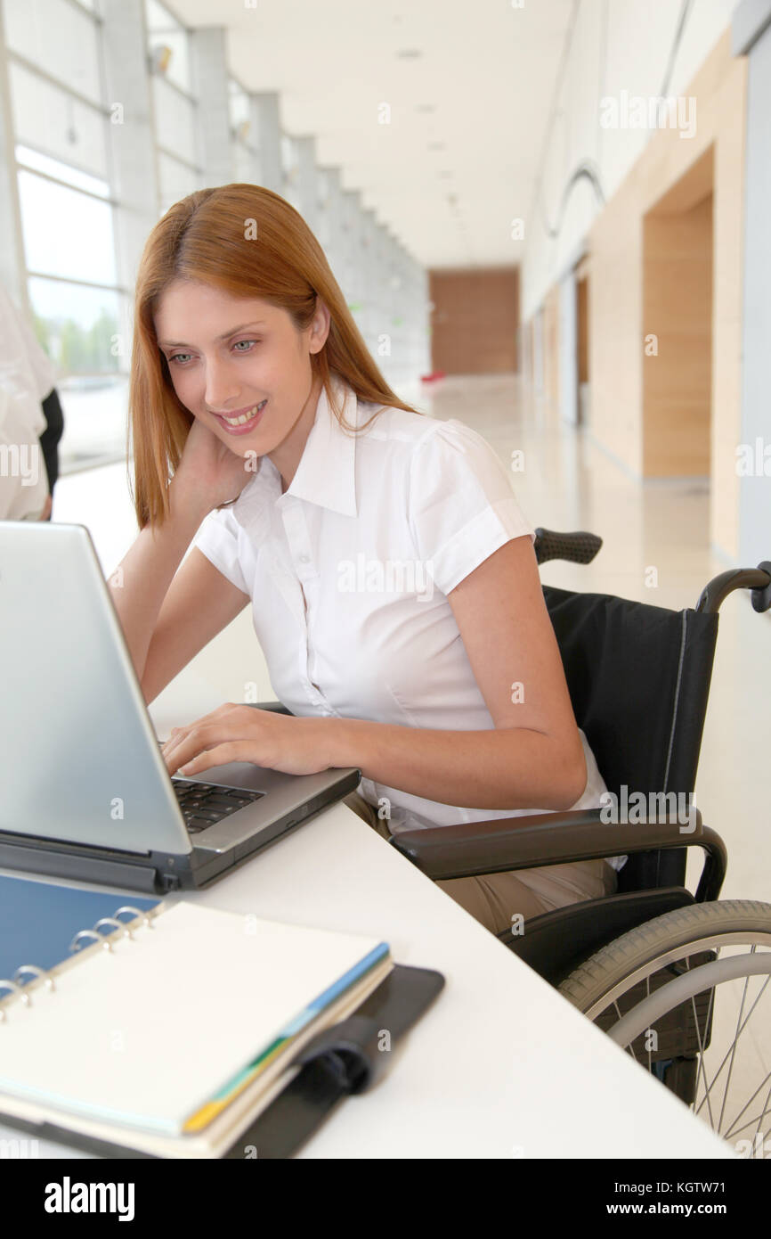 Handicapped woman in office Stock Photo - Alamy