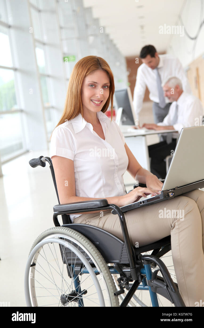 Businesswoman in wheelchair at work Stock Photo - Alamy