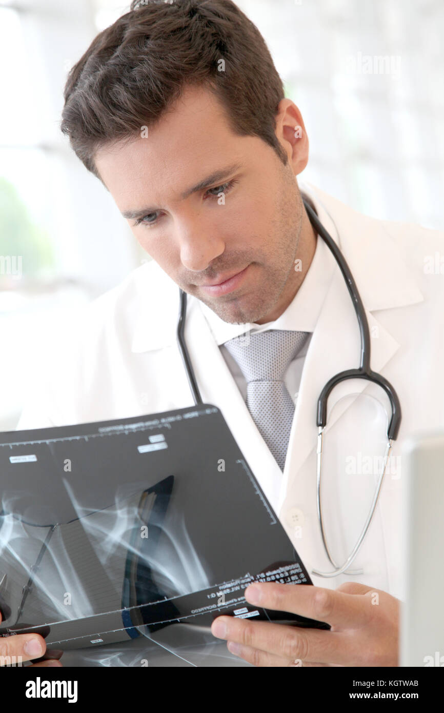 Portrait of young doctor checking X-Ray Stock Photo - Alamy