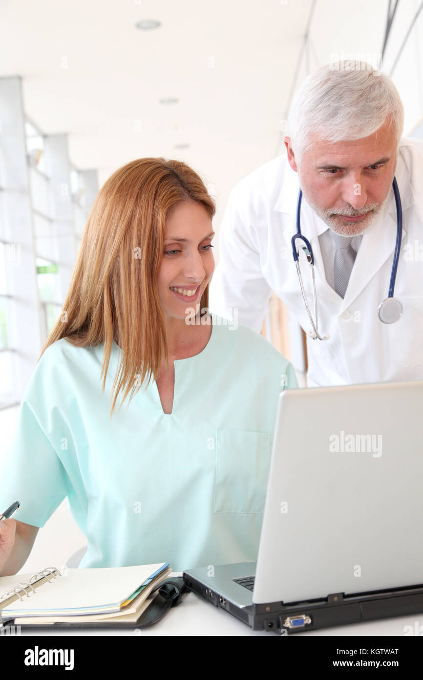 Doctor and intern working in hospital Stock Photo - Alamy