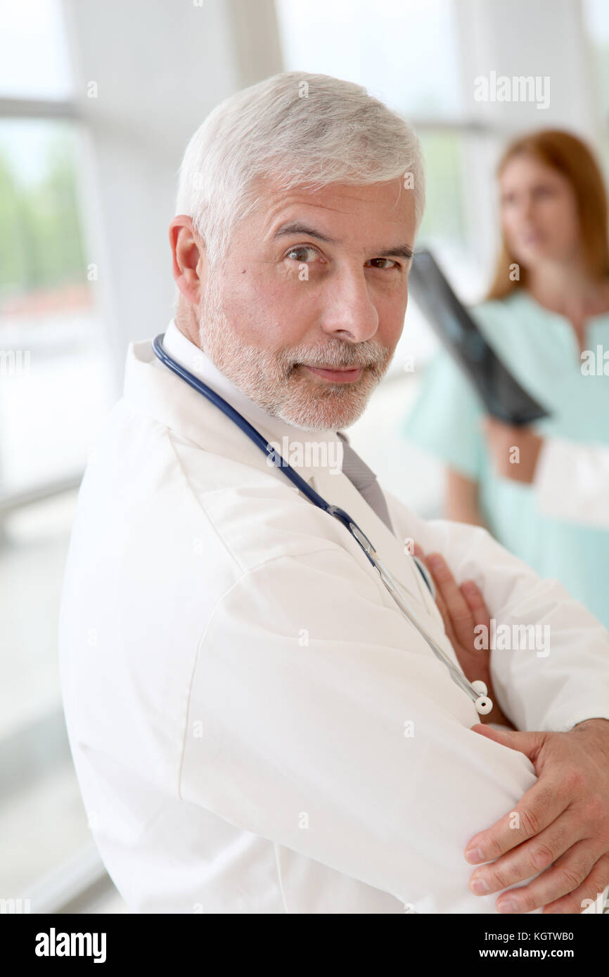 Portrait of smiling senior doctor Stock Photo - Alamy