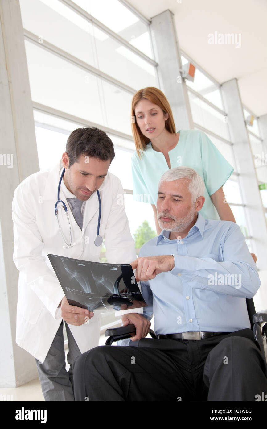 Medical team checking X-ray with patient Stock Photo - Alamy