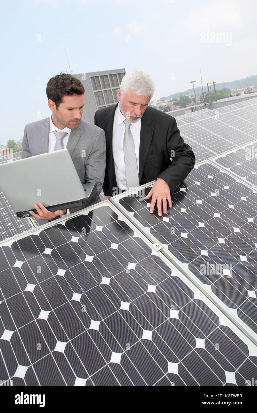Business people standing by solar panels Stock Photo - Alamy