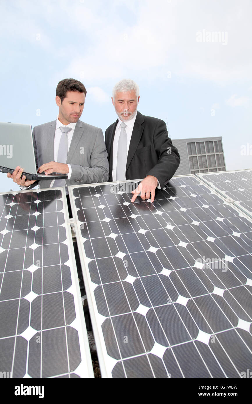 Business people standing by solar panels Stock Photo - Alamy