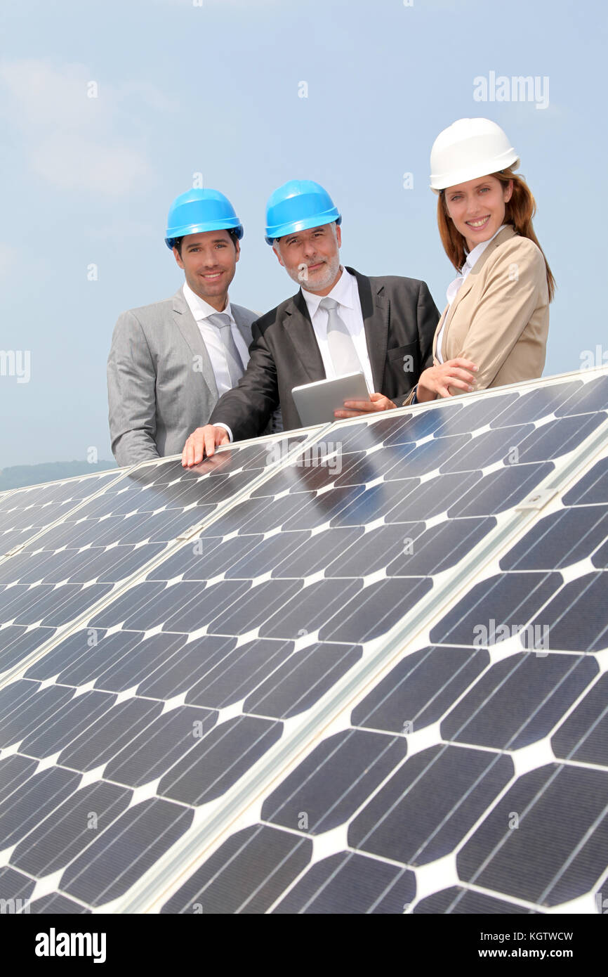 Engineers checking solar panels setup Stock Photo - Alamy