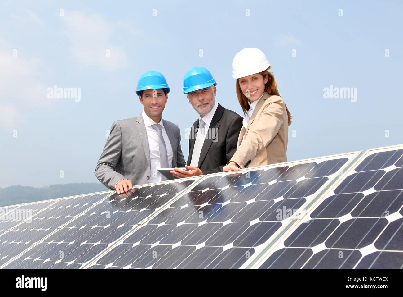 Engineers checking solar panels setup Stock Photo - Alamy