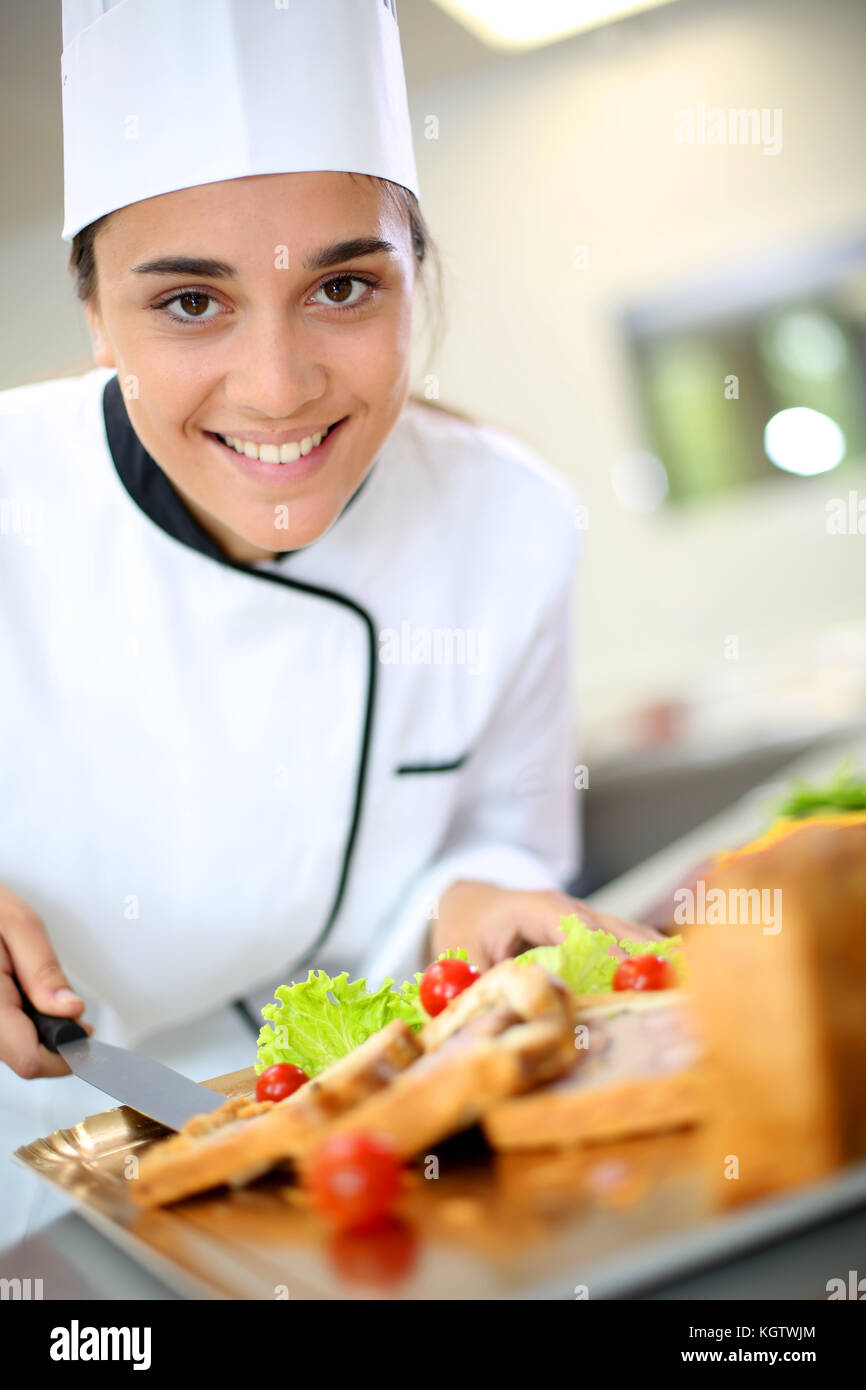 Portrait of beautiful young caterer preparing food tray Stock Photo - Alamy