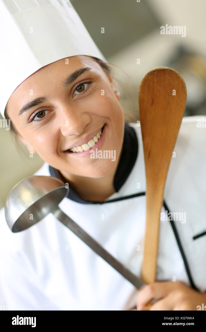 Portrait of happy cook with cap and kitchenware Stock Photo - Alamy